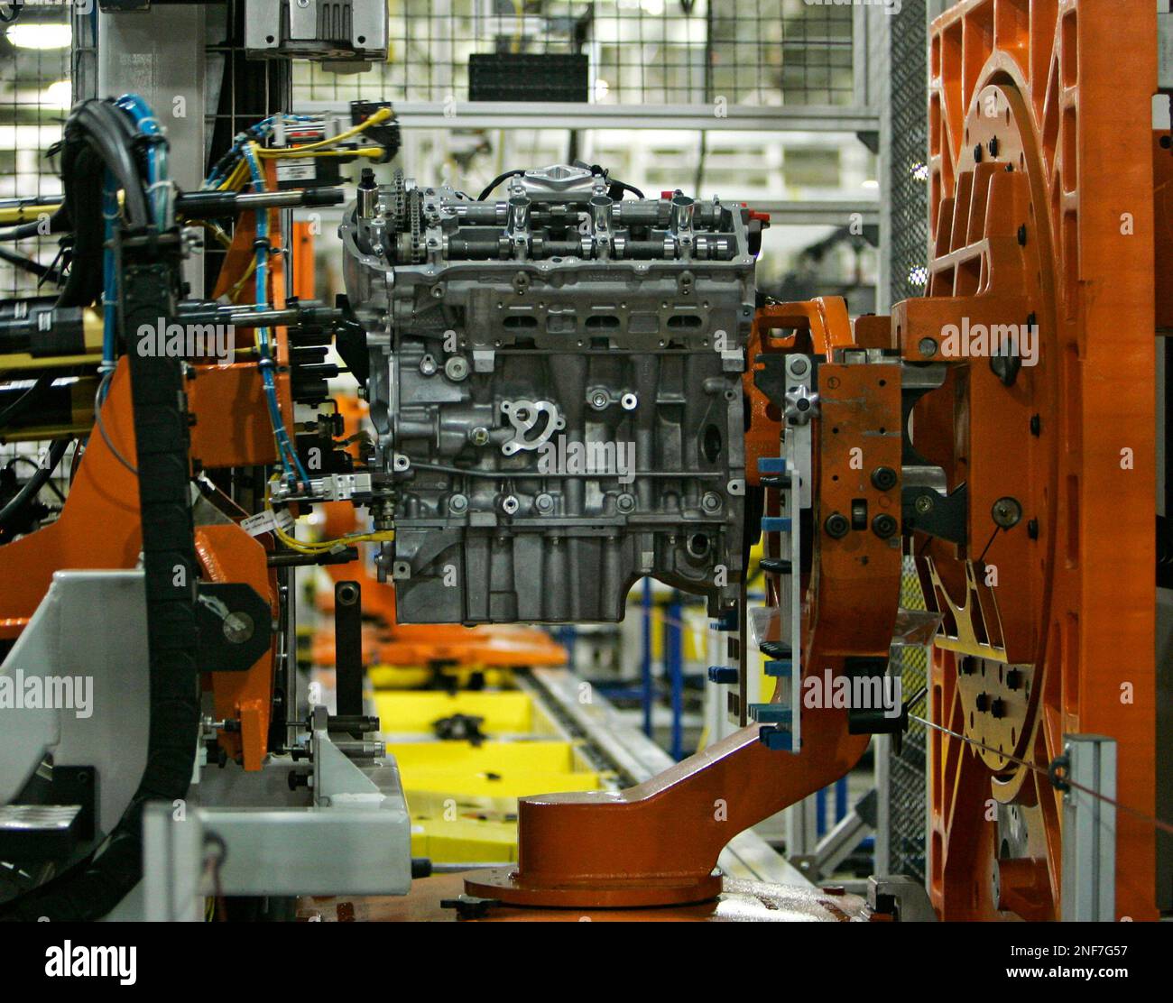A robot attaches the front cover on a pre-production model of Ford's ...