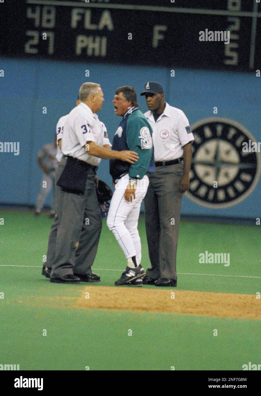 Crew chief Drew Coble, left, holds back Seattle Manager Lou Piniella ...