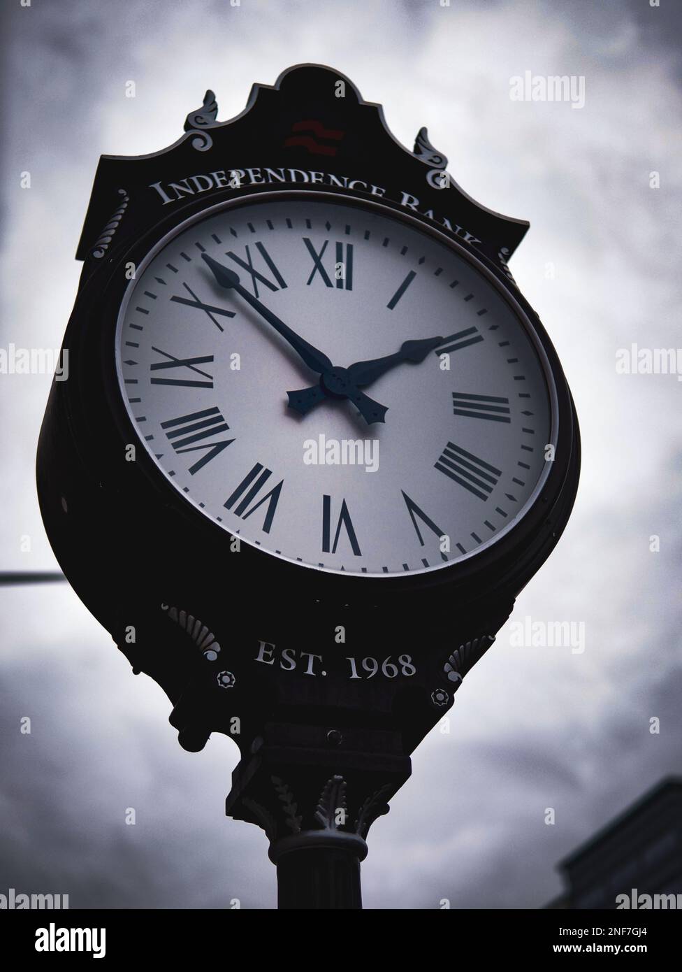 A clock showing time with text 'independence bank' Stock Photo - Alamy