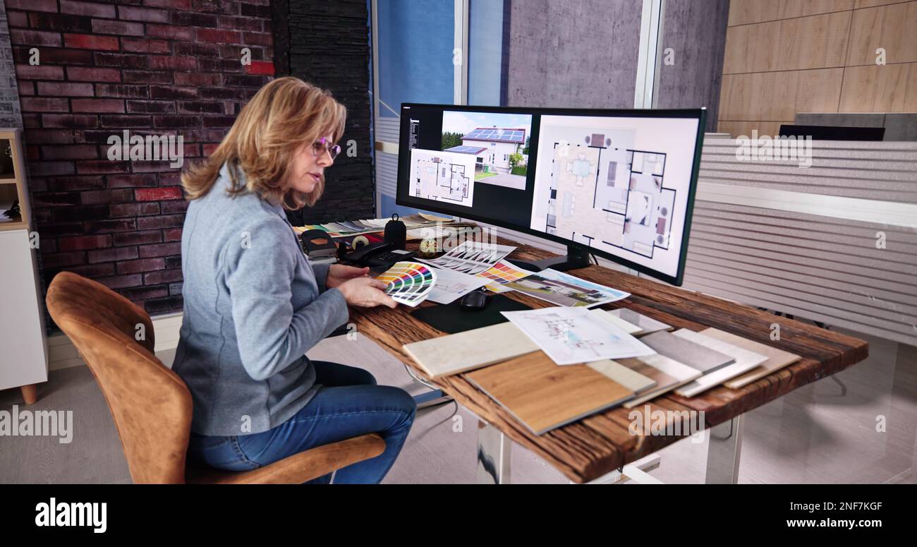 Side View Of Real Estate Designer Working On Computer In Office Stock ...