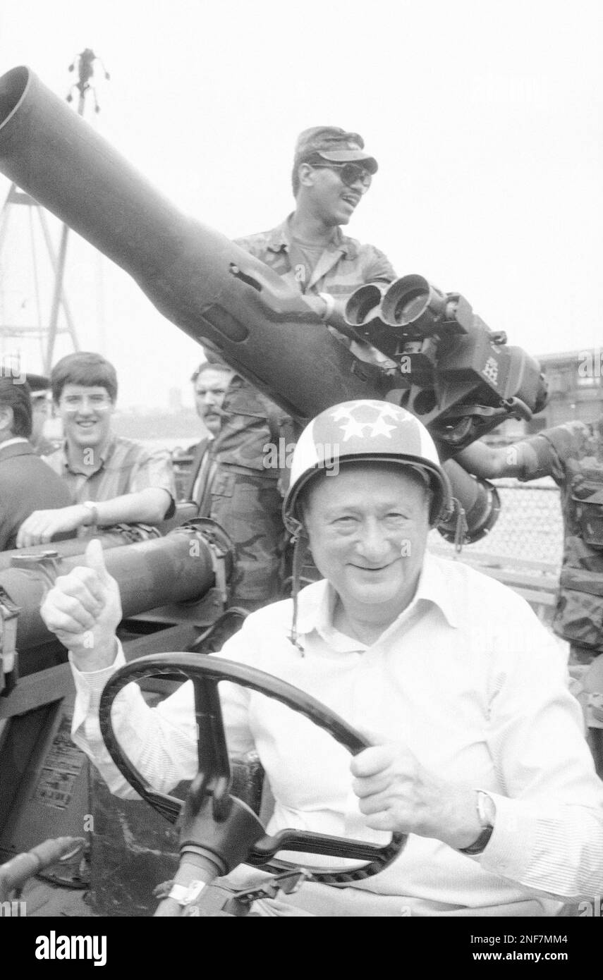 New York Mayor Edward I. Koch sits in an Army jeep armed with a rocket launcher during the ...