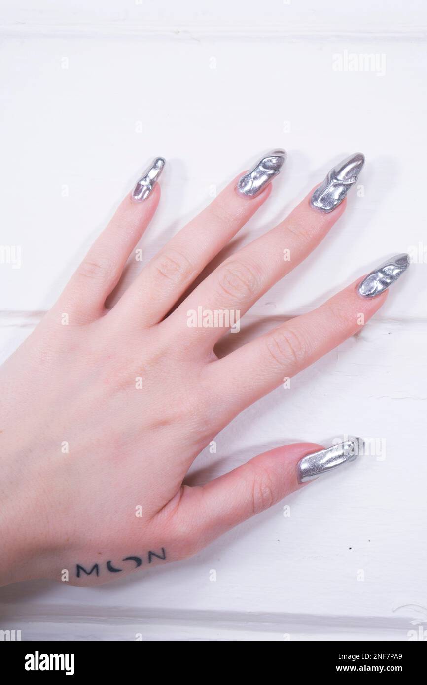Photographic documentation depicting the hands of a young white skinned ...