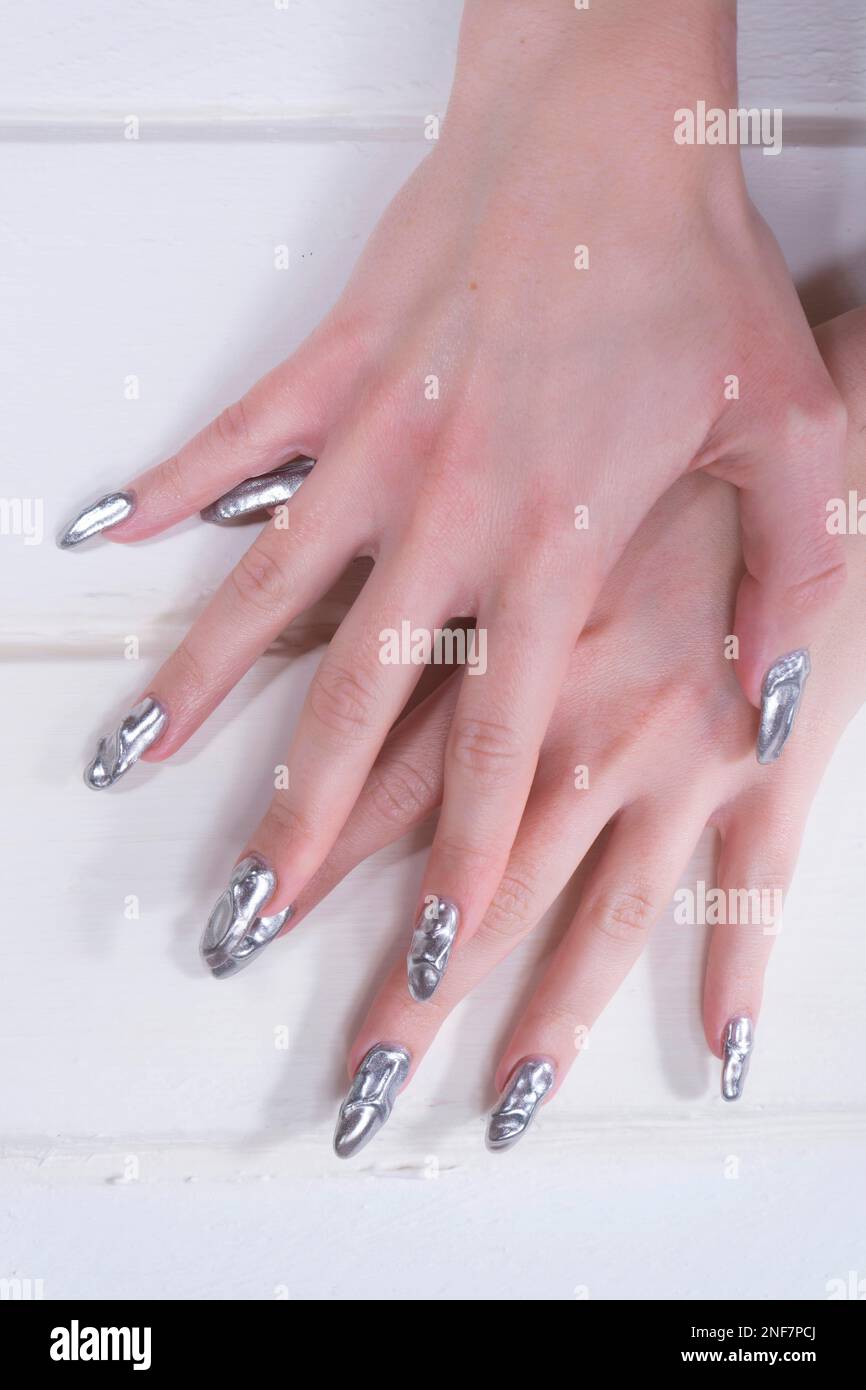 Photographic documentation depicting the hands of a young white skinned ...