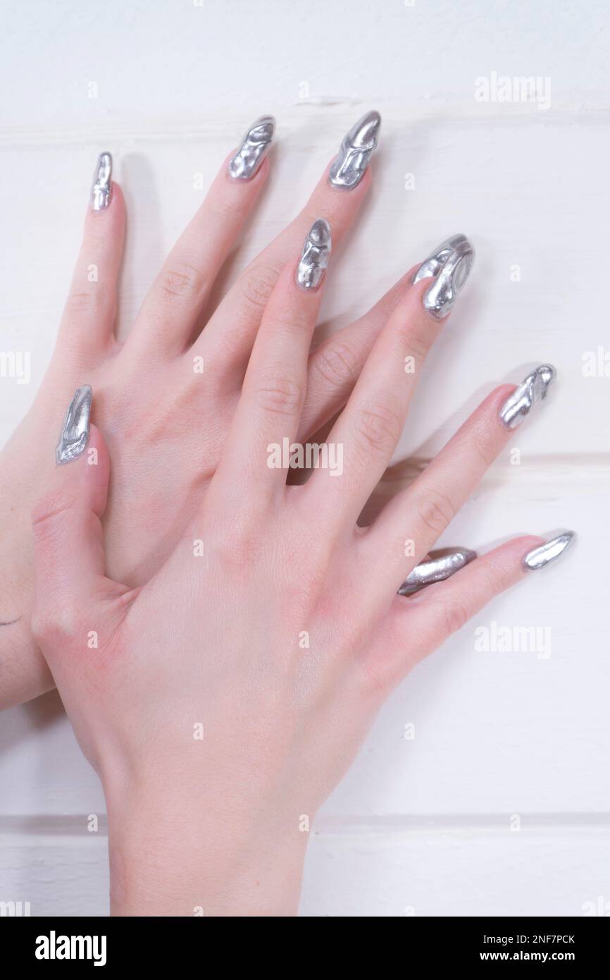 Photographic documentation depicting the hands of a young white skinned ...
