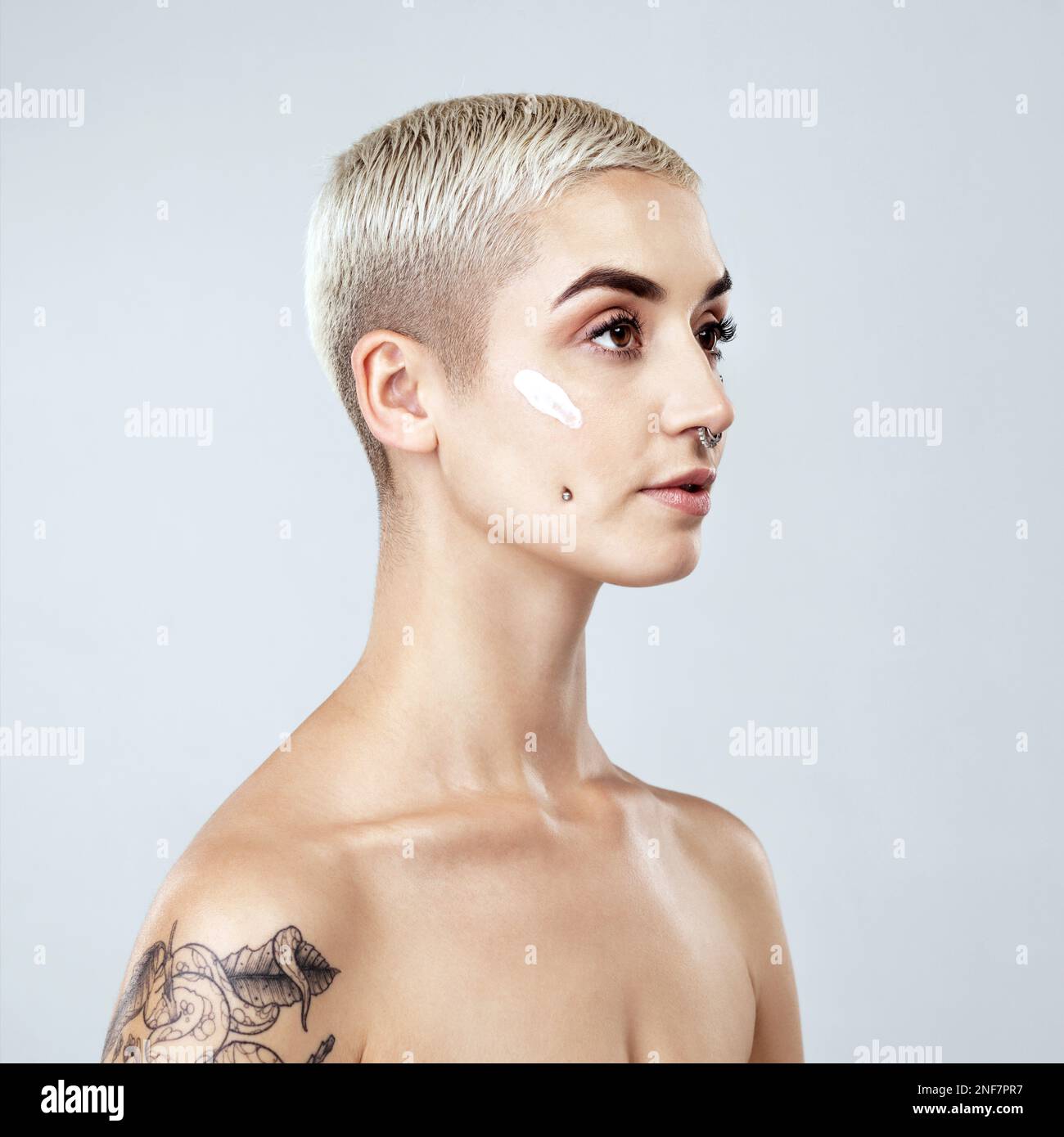 Theres only one product that I trust. Studio shot of a beautiful young woman posing against a ...