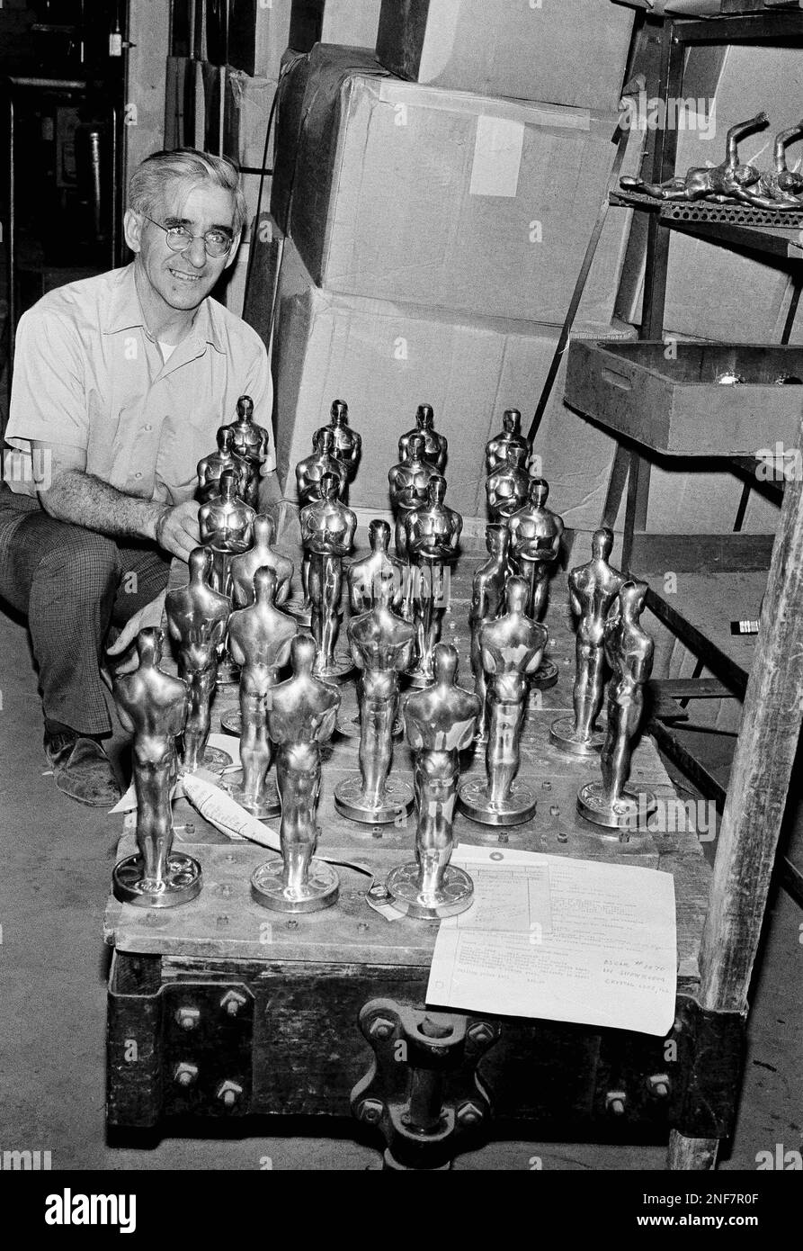 John Lippert of Chicago looks over a flat load of Oscars in a cluttered ...