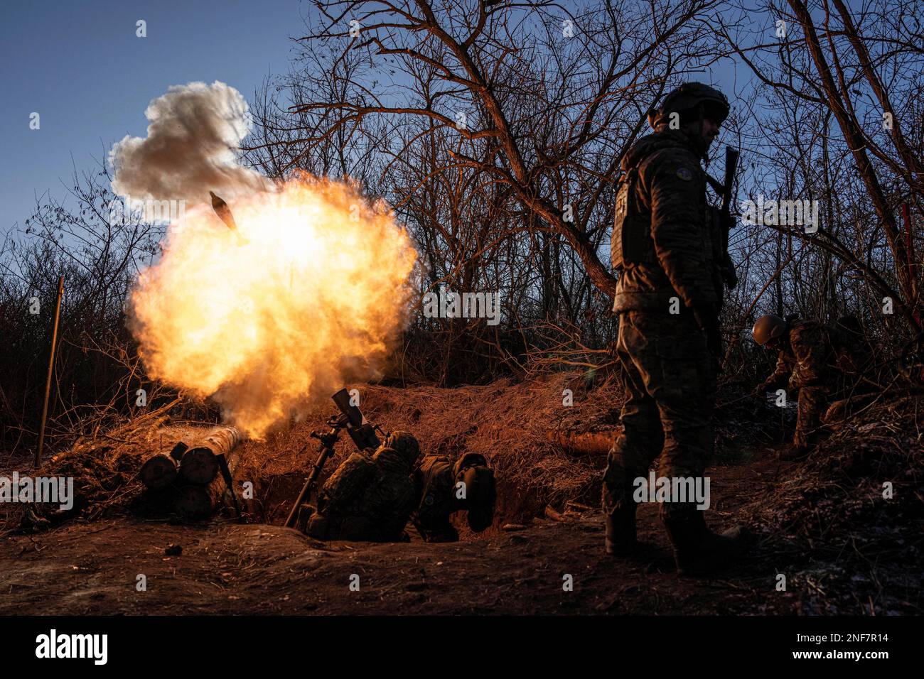 FILE - Ukrainian servicemen fire a 120mm mortar towards Russian ...