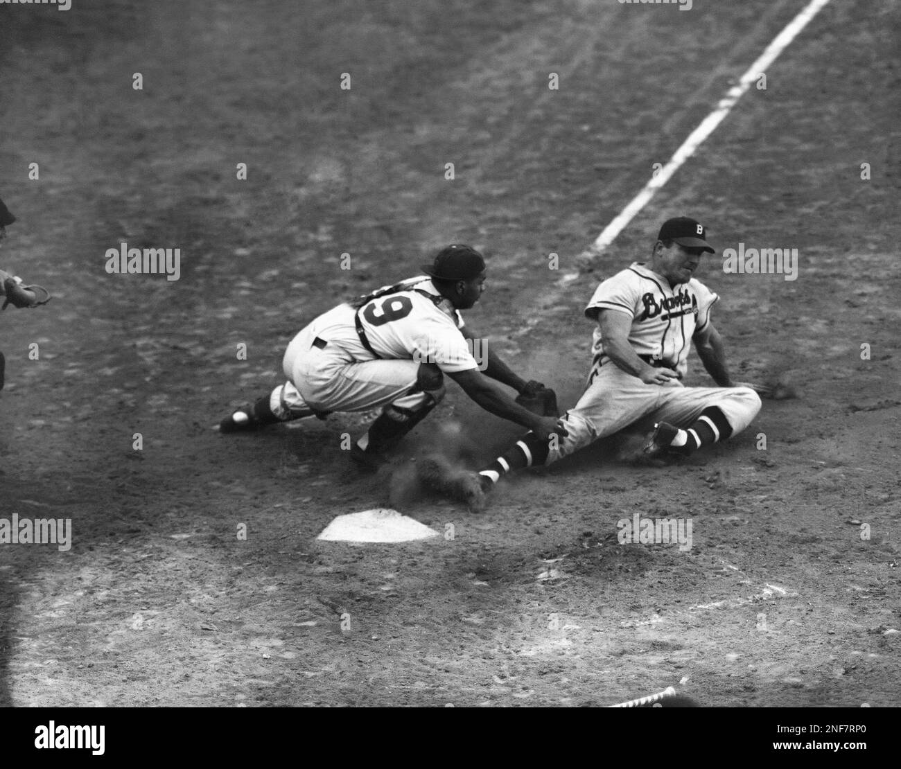 Boston Braves left fielder Jeff Heath, sliding, fractures his left foot ...