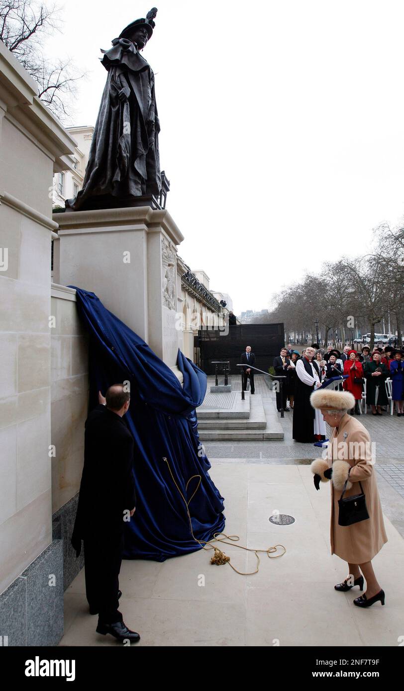 Britain's Queen Elizabeth II unveils a memorial to Queen Elizabeth, the ...