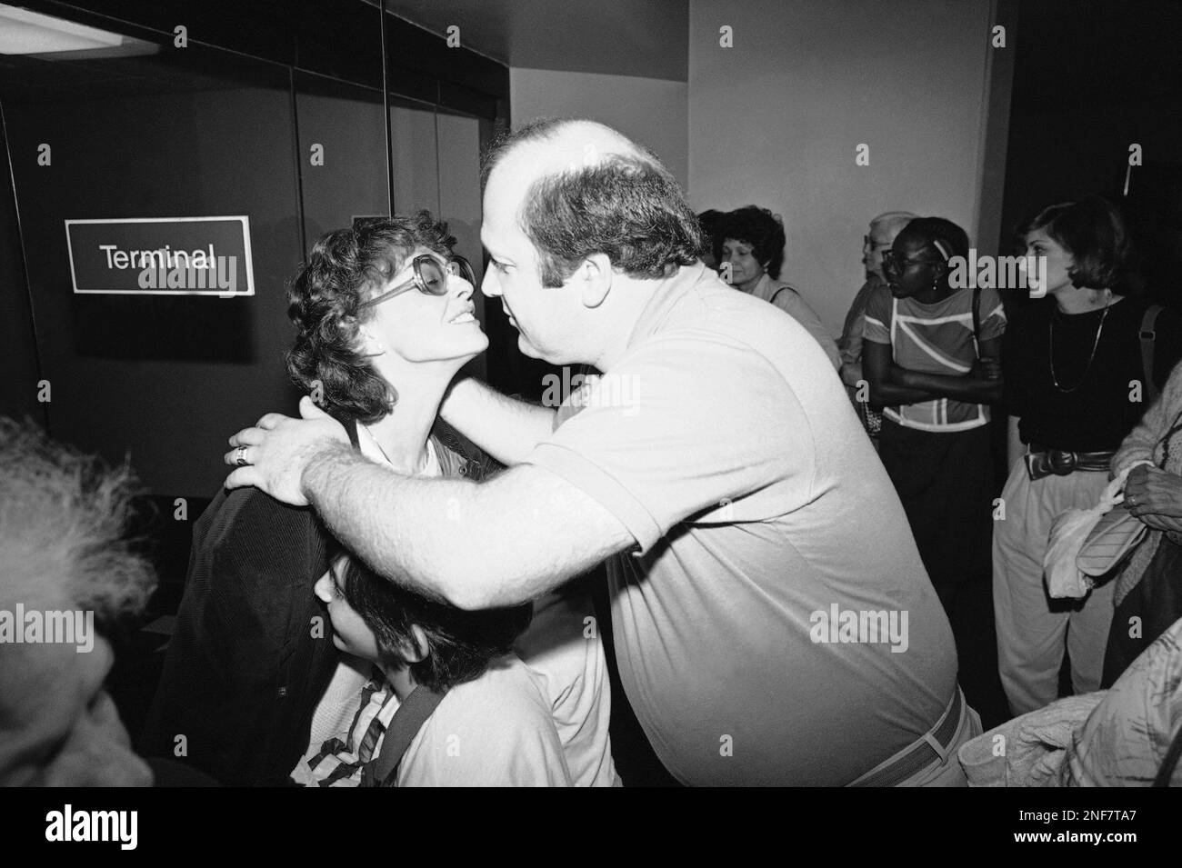 Beverly Zitner of Hollywood, Fla., is kissed by her husband Chuck after ...