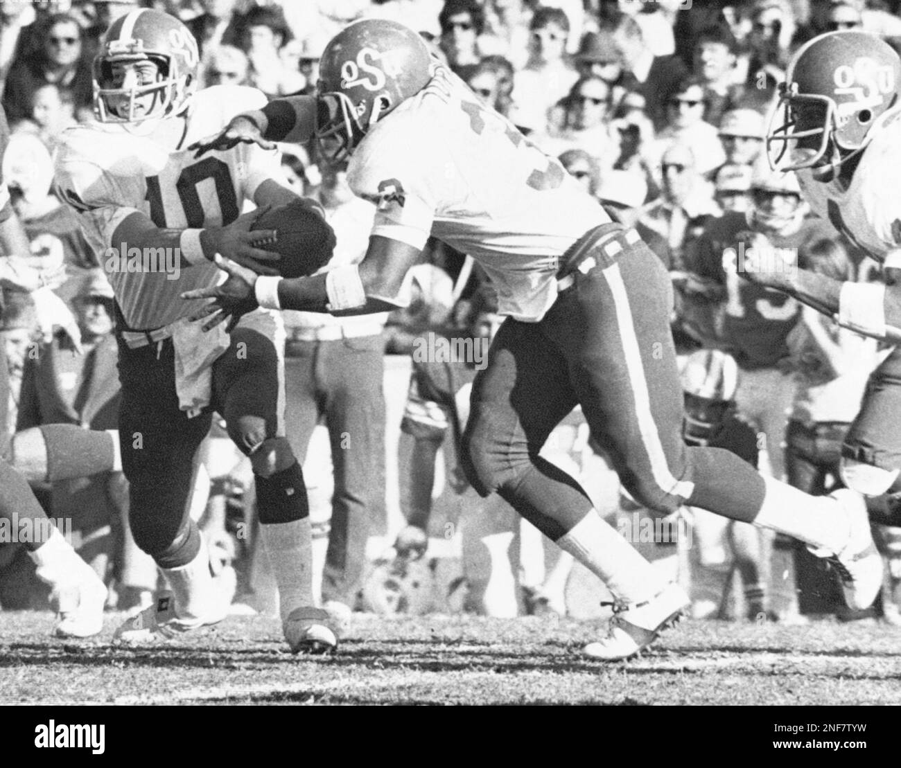 Oklahoma State quarterback Scott Burk, left, hands off to Robert Turner ...