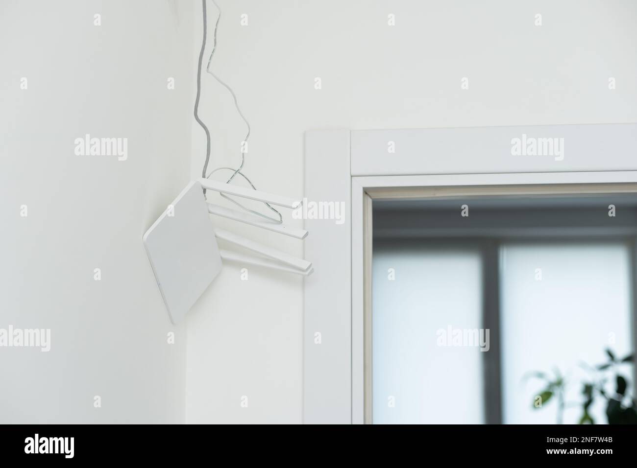 Modern WiFi router on light wall in home office Stock Photo - Alamy