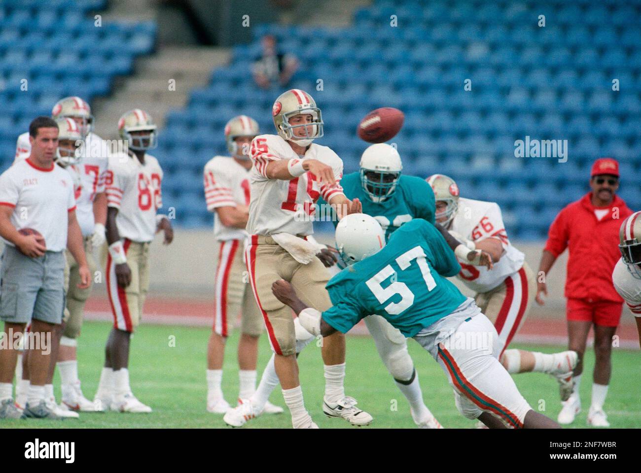 John Paye (left, no. 15) of the San Francisco 49ers passes the ball as ...