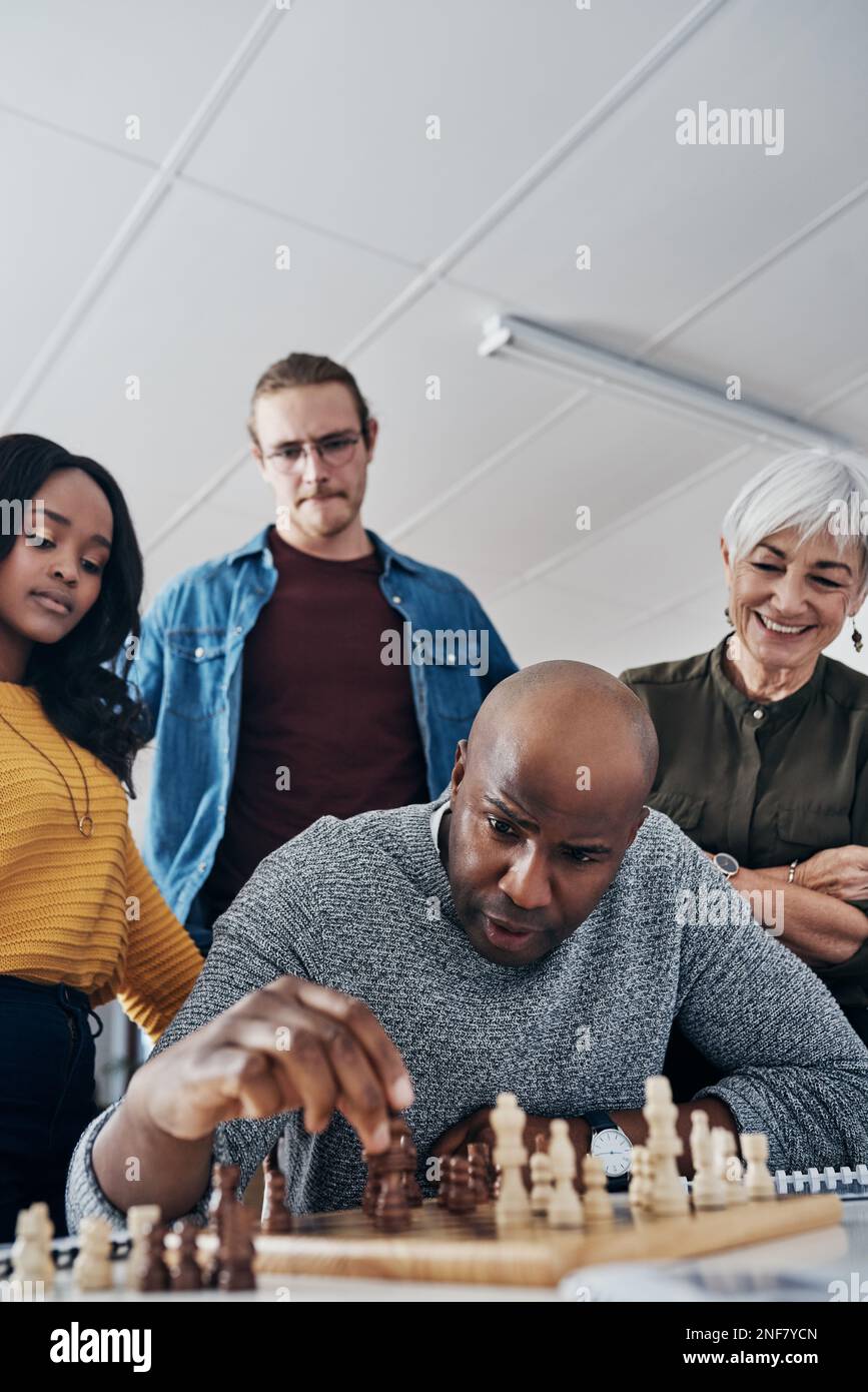 He always plays to win. a mature businessman playing chess in his ...