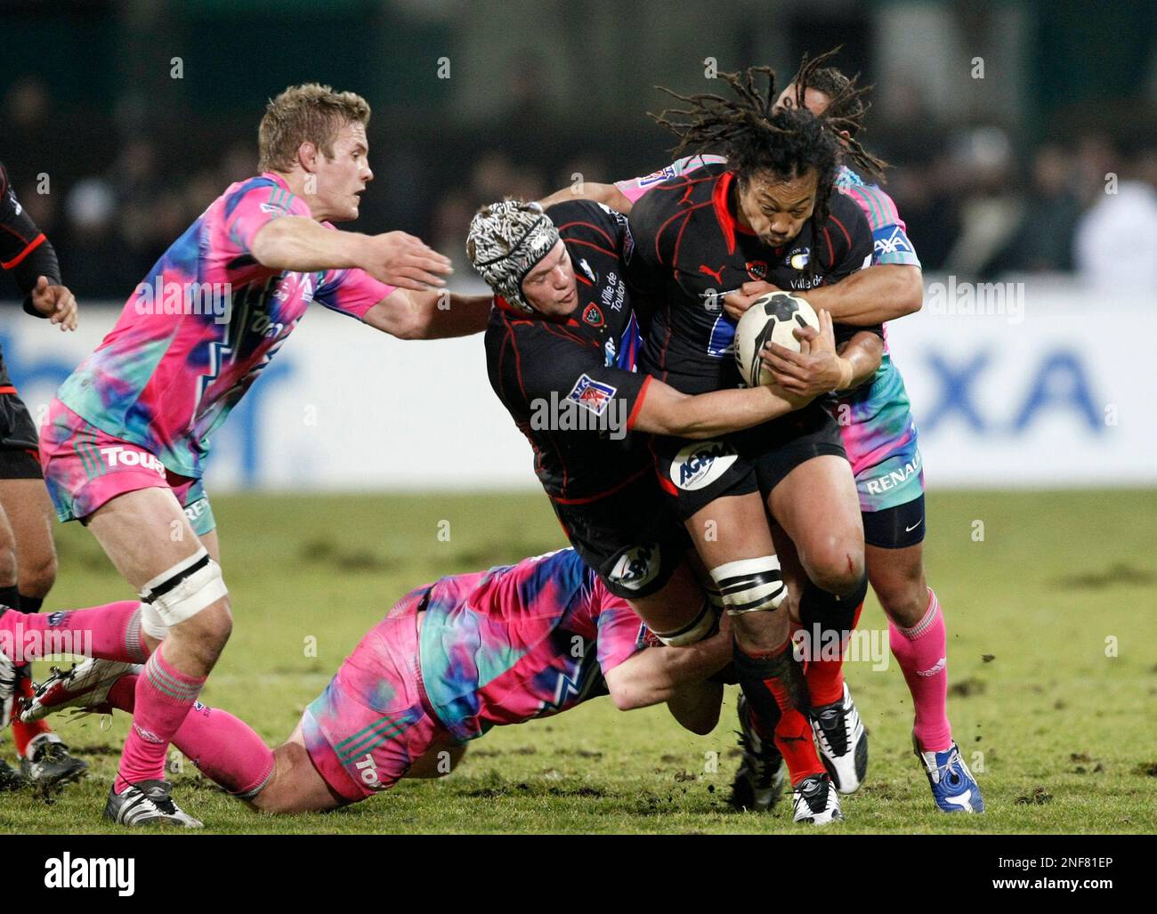 New Zealand Tana Umaga of Toulon, second from right, is tackled by ...