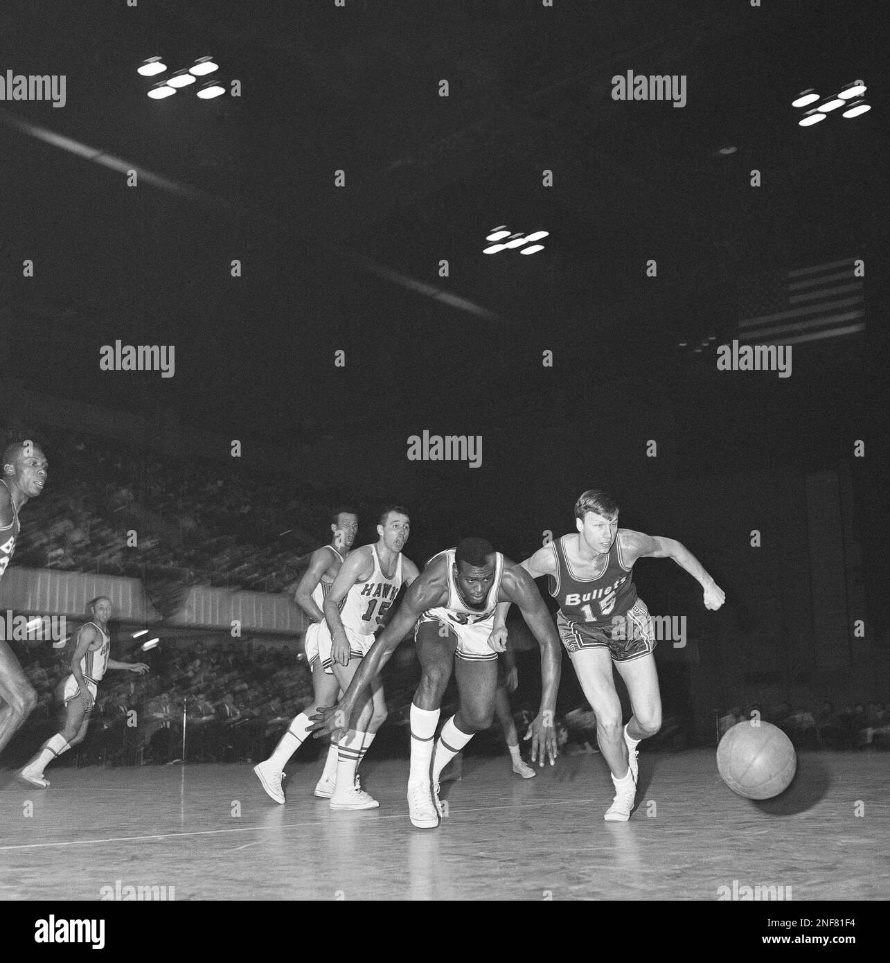 St. Louis Hawks Richie Guerin (15) watches from background, open-mouth ...