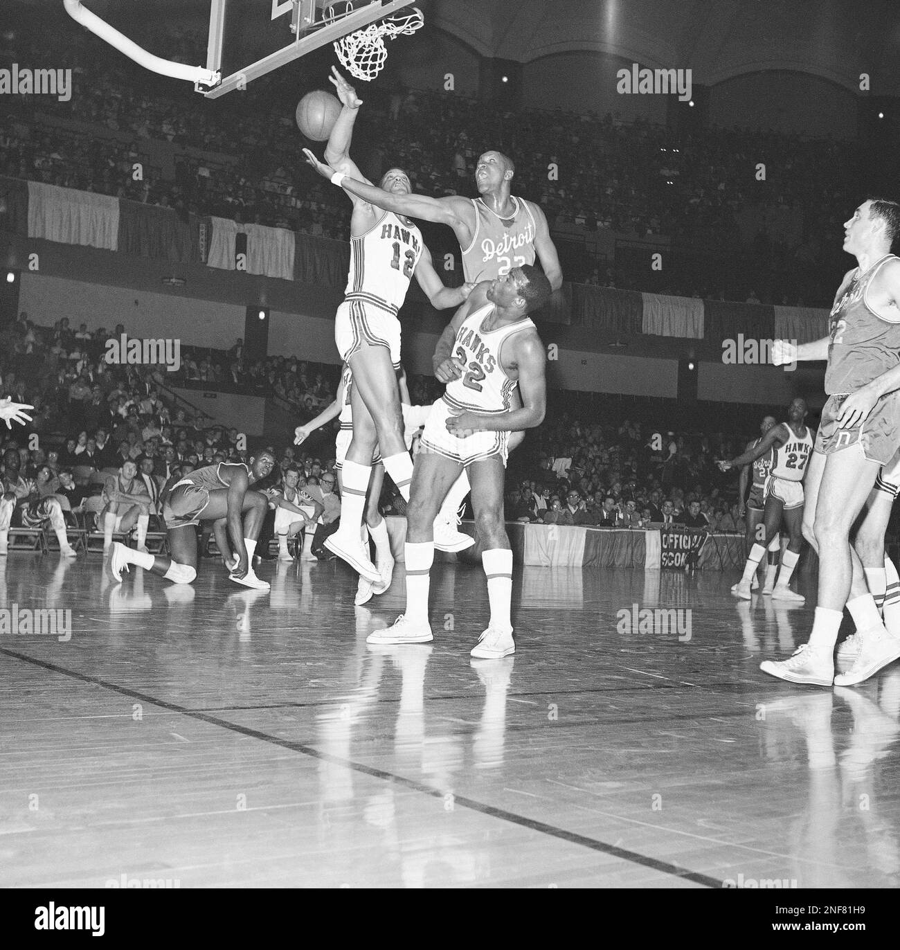 The Detroit Pistons John Tresvant, 23, begins to leap over Bill Bridges ...