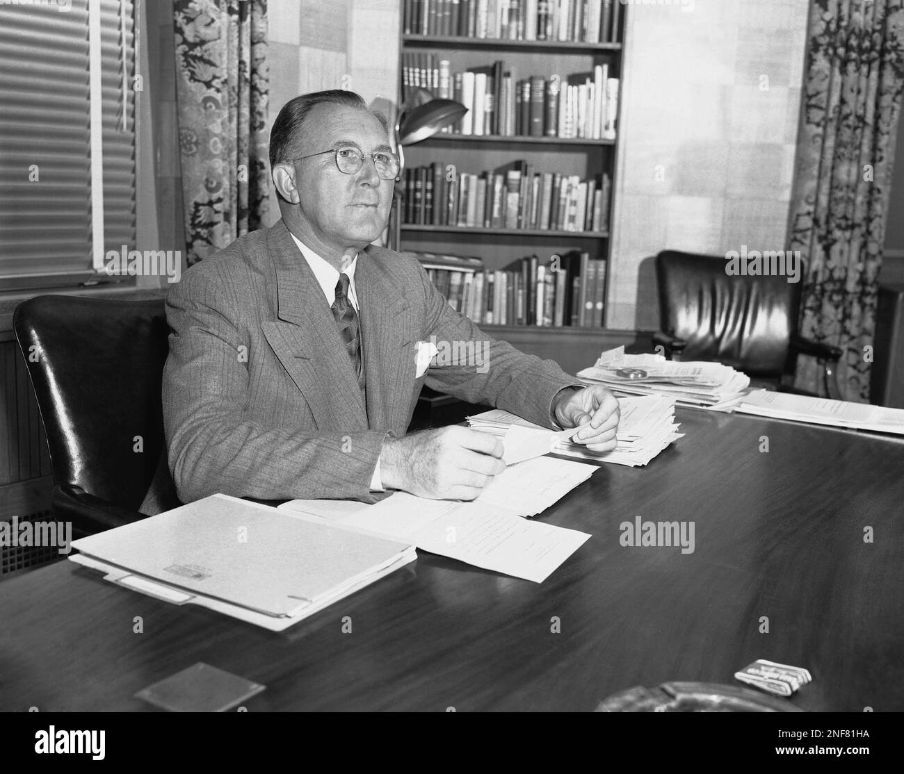 Charles E. Wilson sits at a desk in his New York office, Aug. 31, 1949 ...