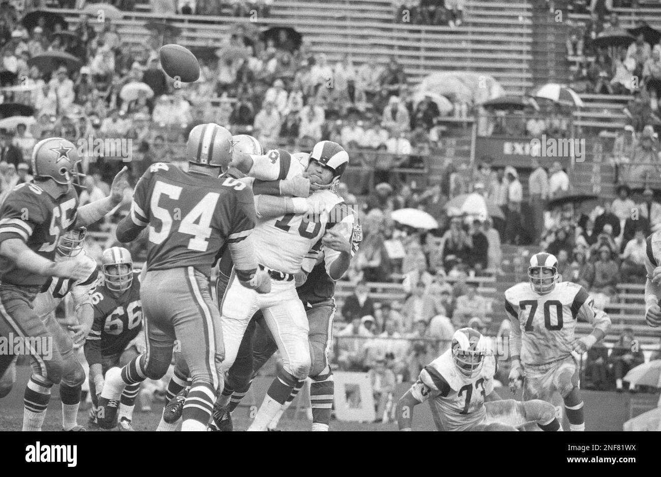 Los Angeles Rams quarterback Roman Gabriel, center, is hit by a host of ...