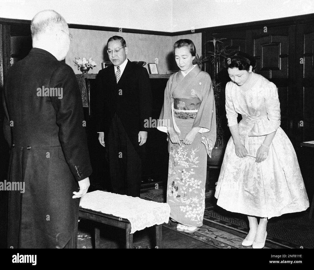 Michiko Shoda bows from the waist as she accepts notification in Tokyo ...