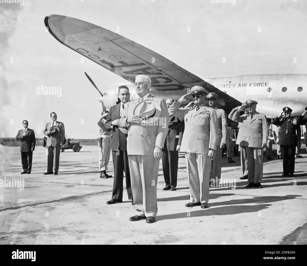 Pres. Harry Truman, front center, stands at attention as the Post Band ...