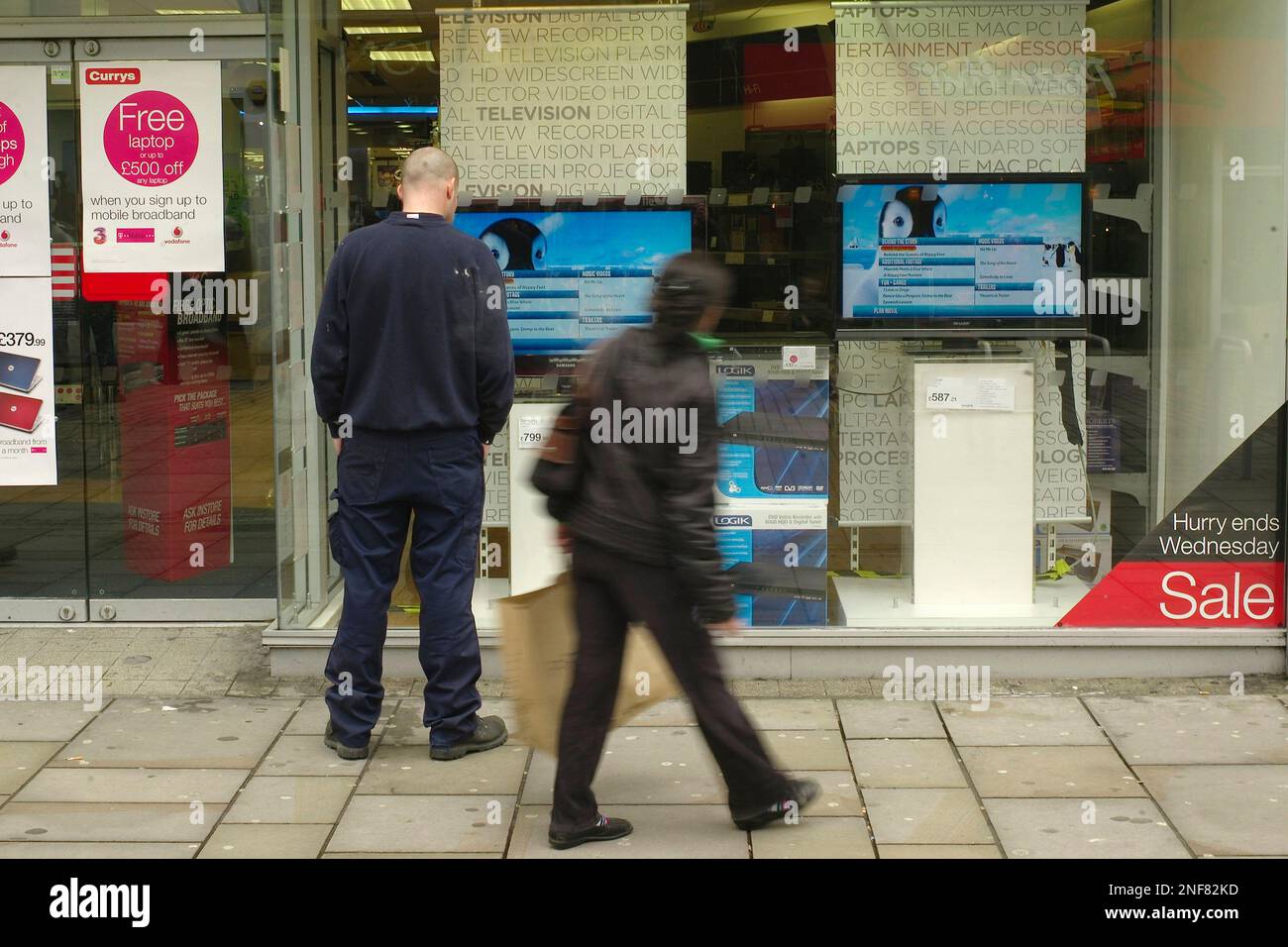 Shoppers look into a shop in Croydon, south London, Friday, Feb. 20 ...