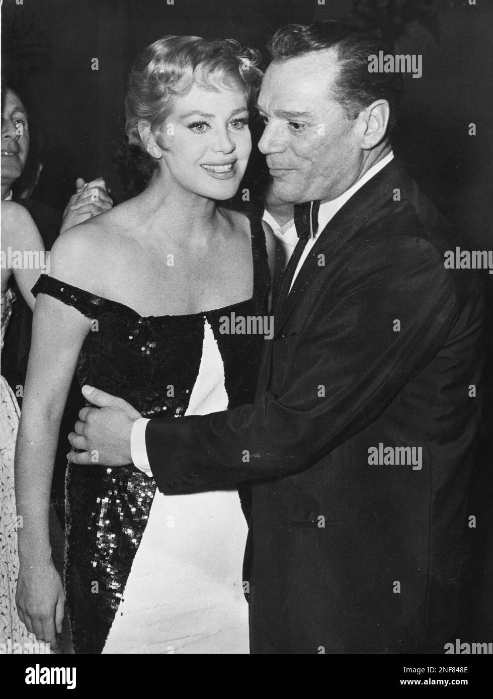 U.S. American actor and singer Eddie Constantine holds the waist of ...