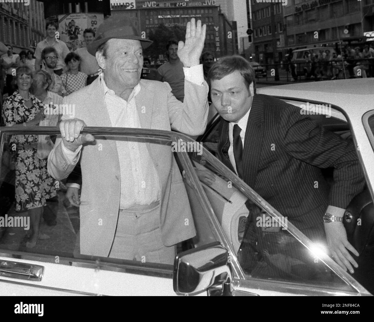 U.S. American actor and singer Eddie Constantine waves to fans as he ...