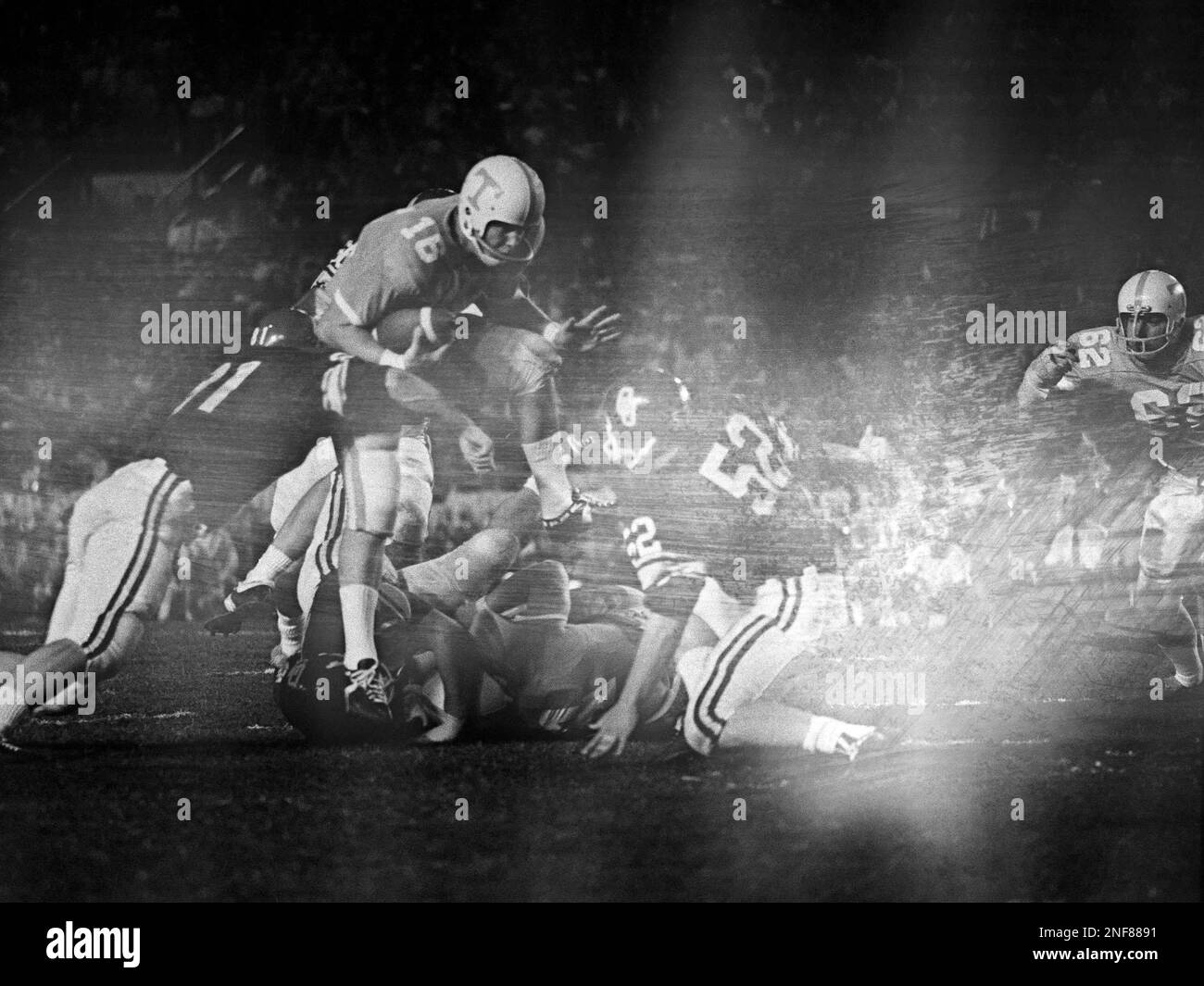 Tennessee quarterback Dewey Warren jumps over the line to gain 6 yards ...