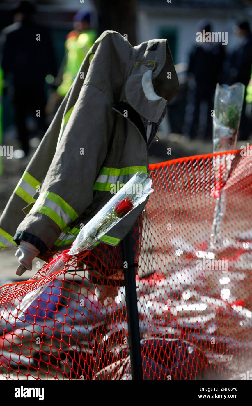 Flowers are left by family members of the victims of a plane crash at ...