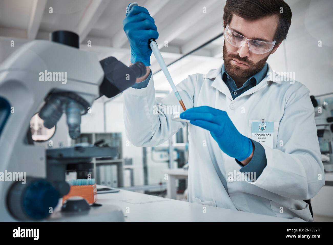 Man working in laboratory, study chemical dna in test tube and research ...