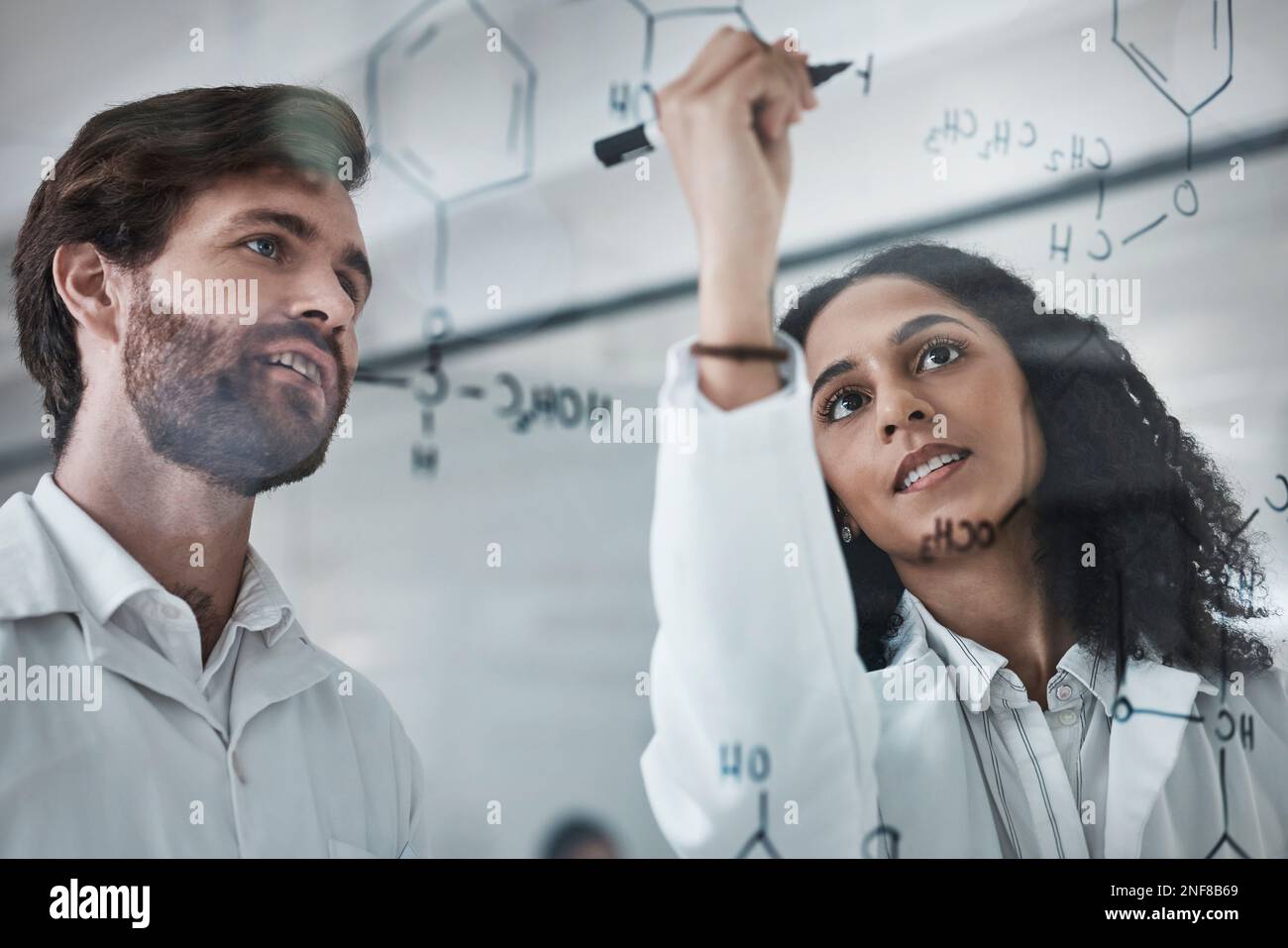 Teamwork, science and chemistry with people writing in laboratory for medicine, pharmacy or ...