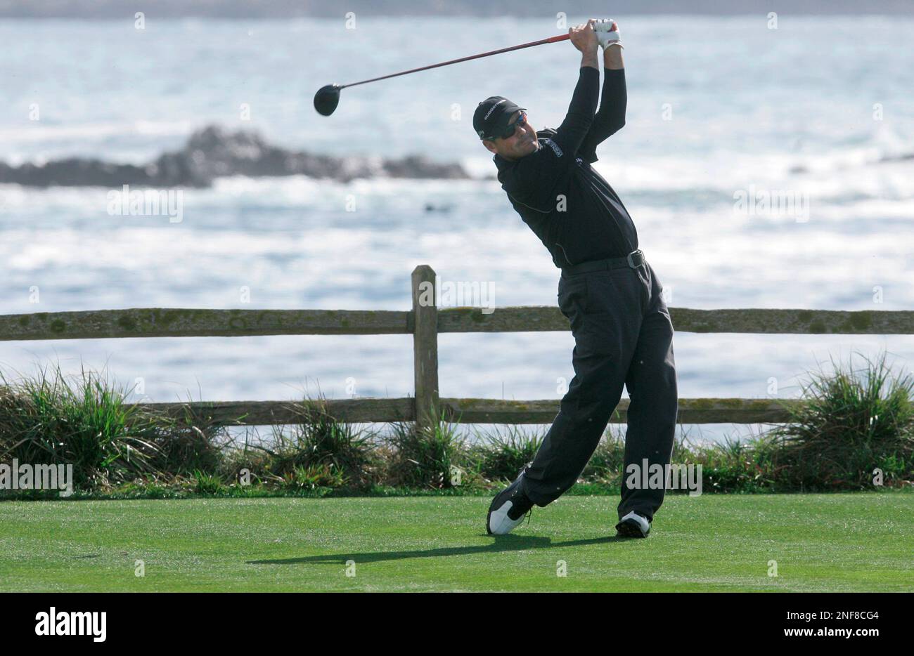 Rich Beem hits from the 18th tee at Pebble Beach golf links during the ...