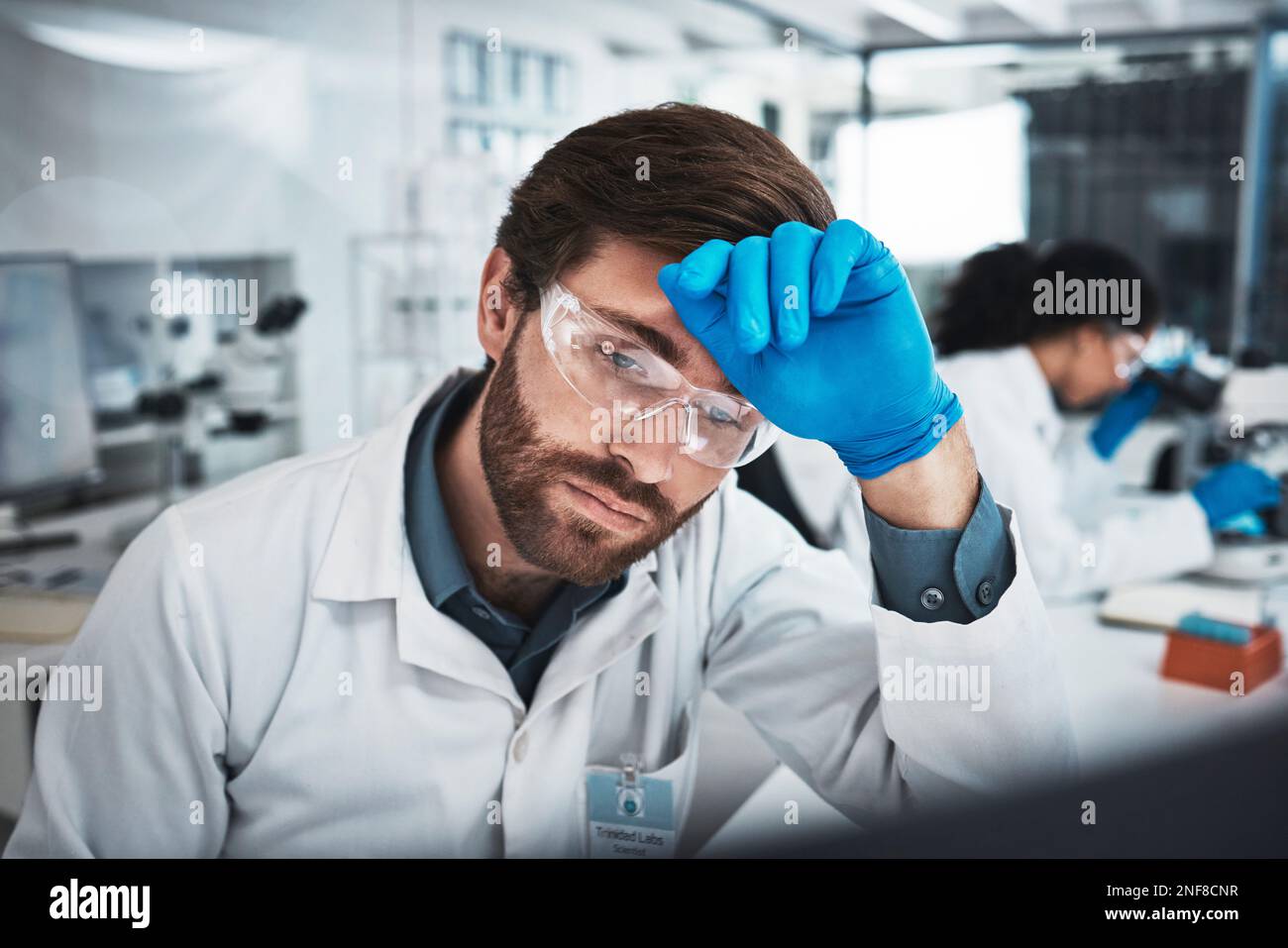 Tired man, doctor and scientist with headache at night suffering from ...