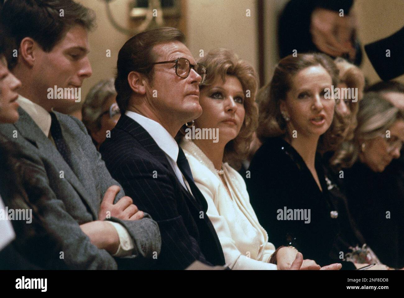 Actor Roger Moore, second from left, is flanked by his Italian-born ...