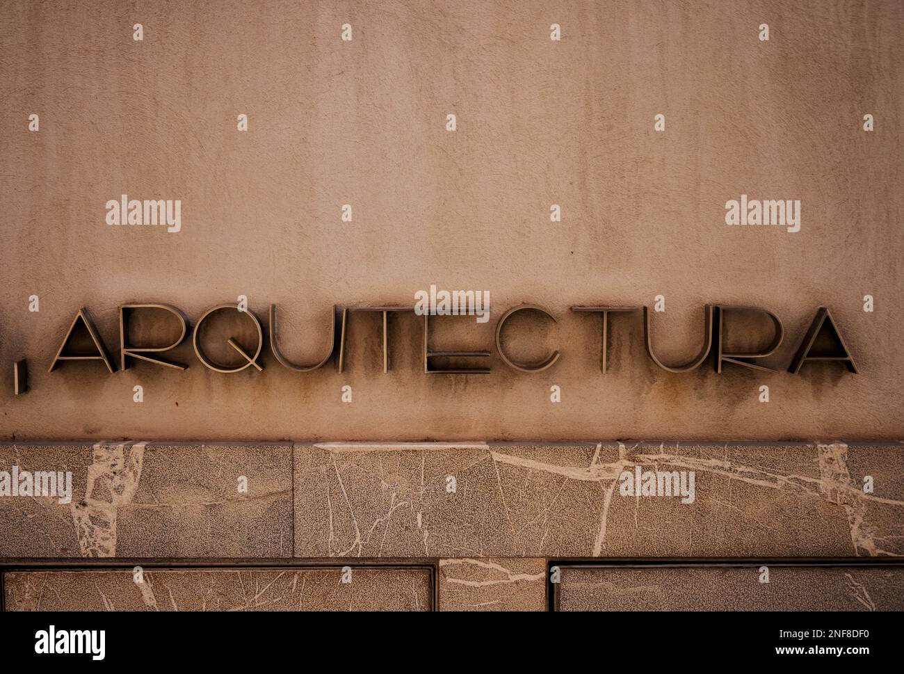 The spanish Arquitectura word meaning Architecture on a stone facade ...