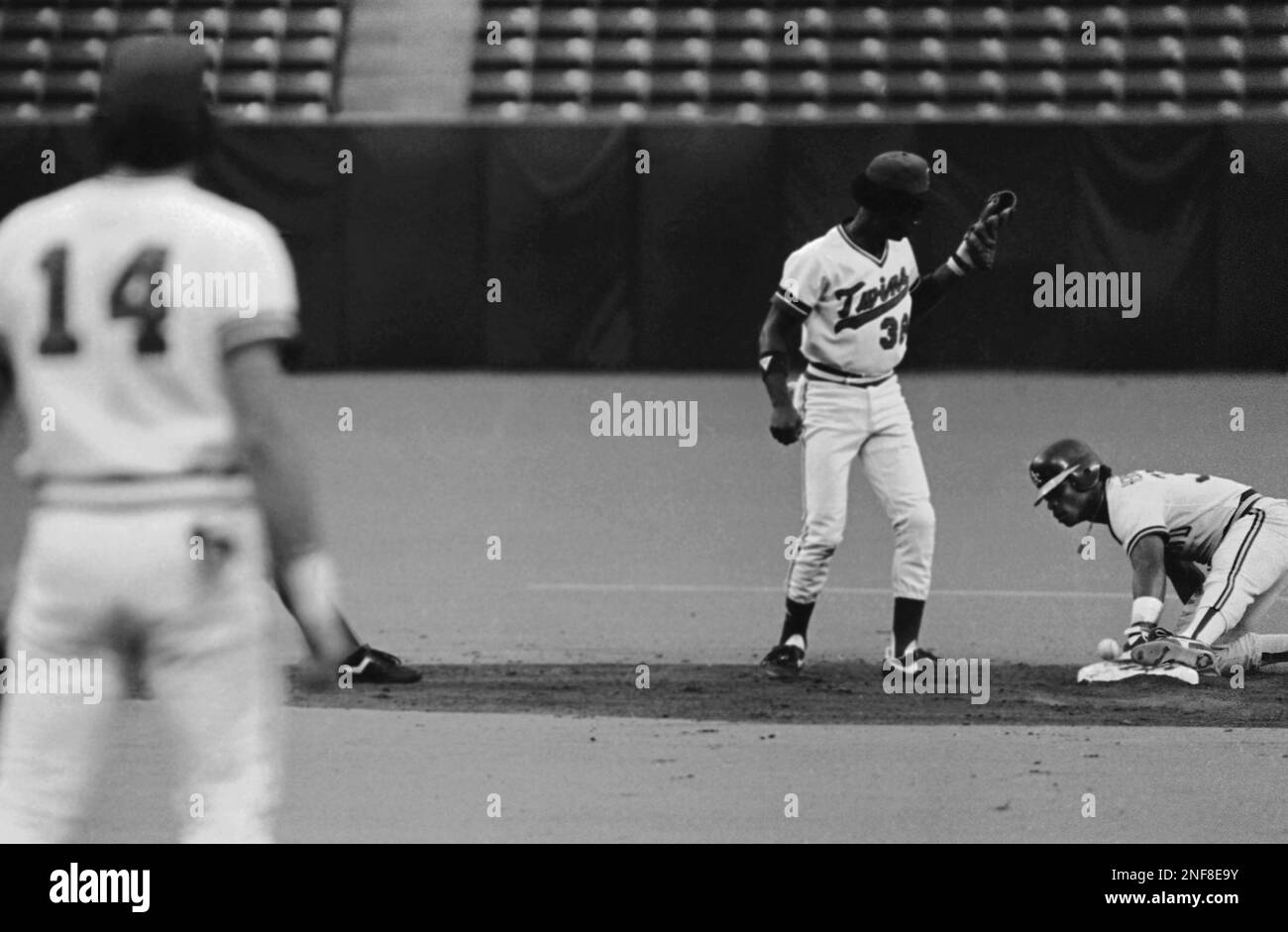 The Oakland A's Rickey Henderson, right, looks up from second base as ...