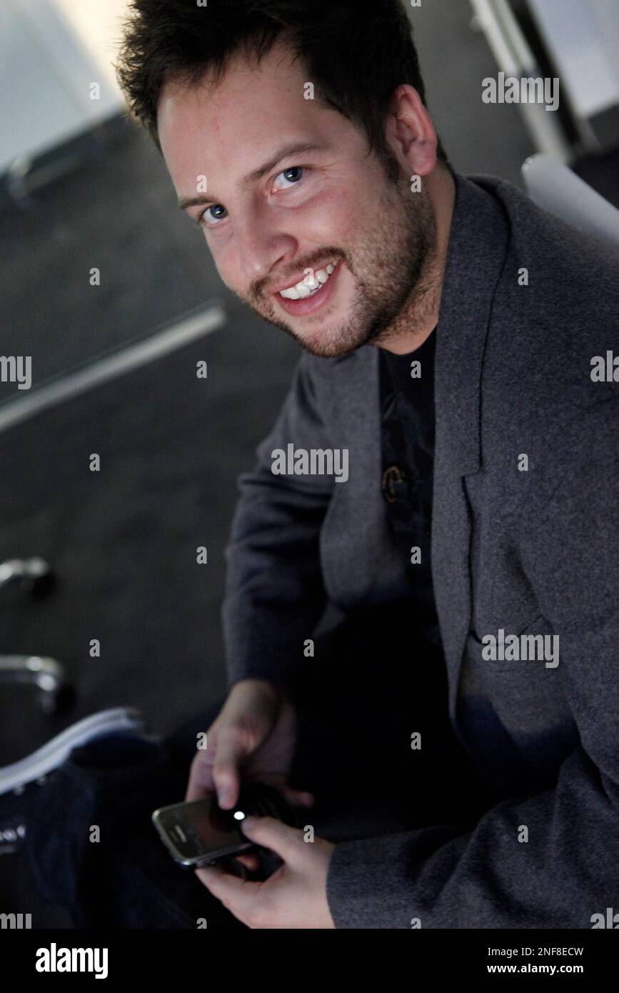 Tyler Barnett poses for a portrait while holding his cell phone in Los ...