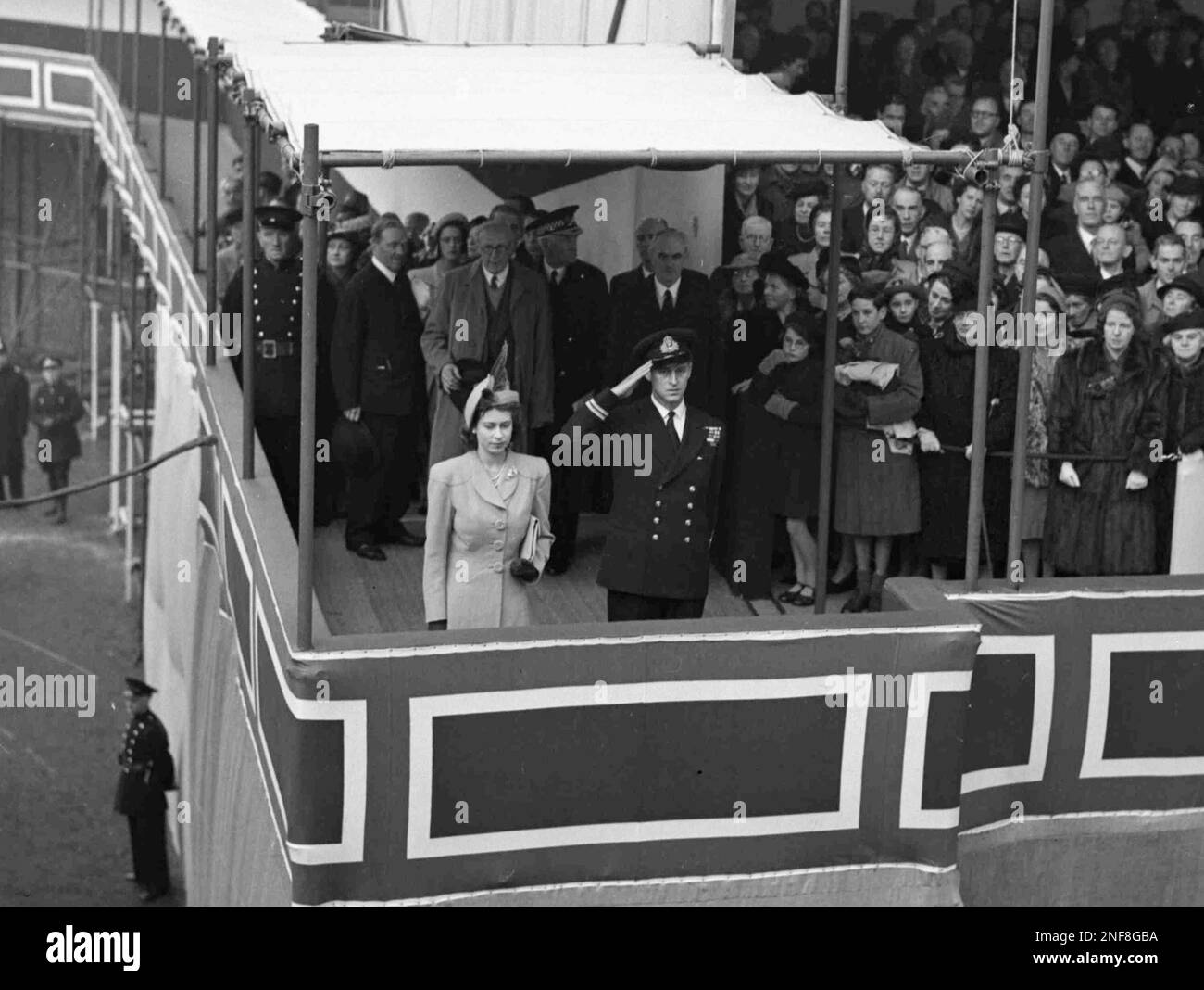 Britain's Princess Elizabeth and her fiance Lieutenant Philip Mountbatten watch the new Cunard ...