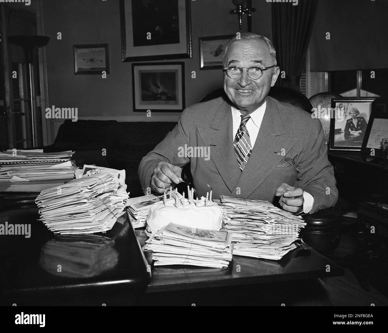President Harry Truman smiles as he lights a birthday cake in his White ...