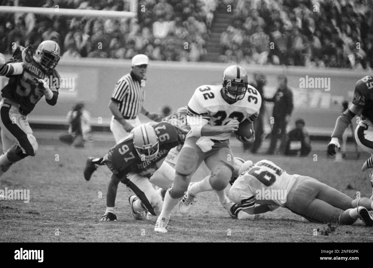 Army FB Doug Black (32) breaks away from Montana DT Larry Oliver (97 ...