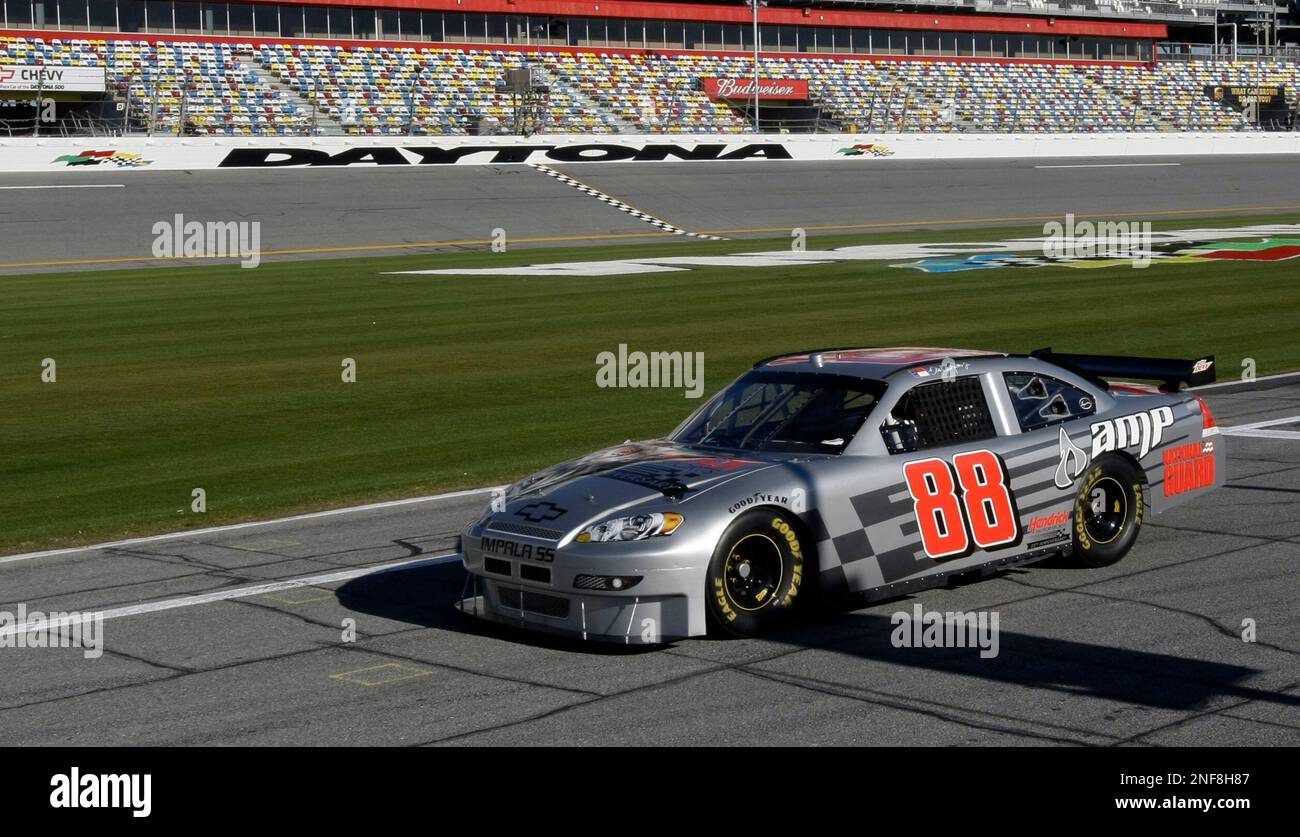 Dale Earnhardt Jr. (88) drives down pit road showing off a new paint ...
