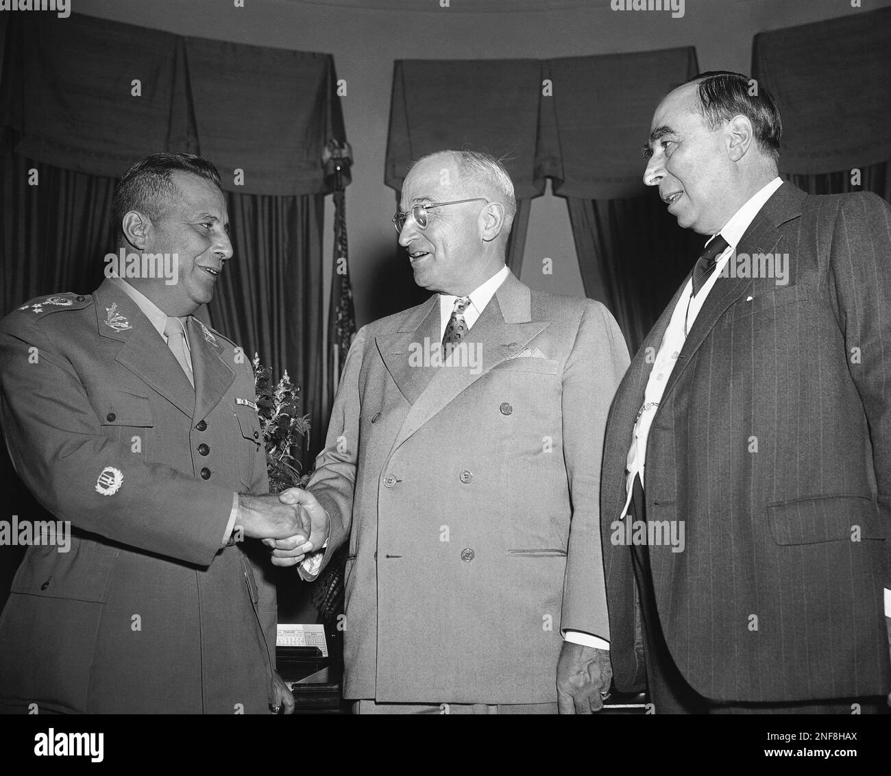 President Harry Truman, center, shakes hands with Maj. Gen. Canrobert ...
