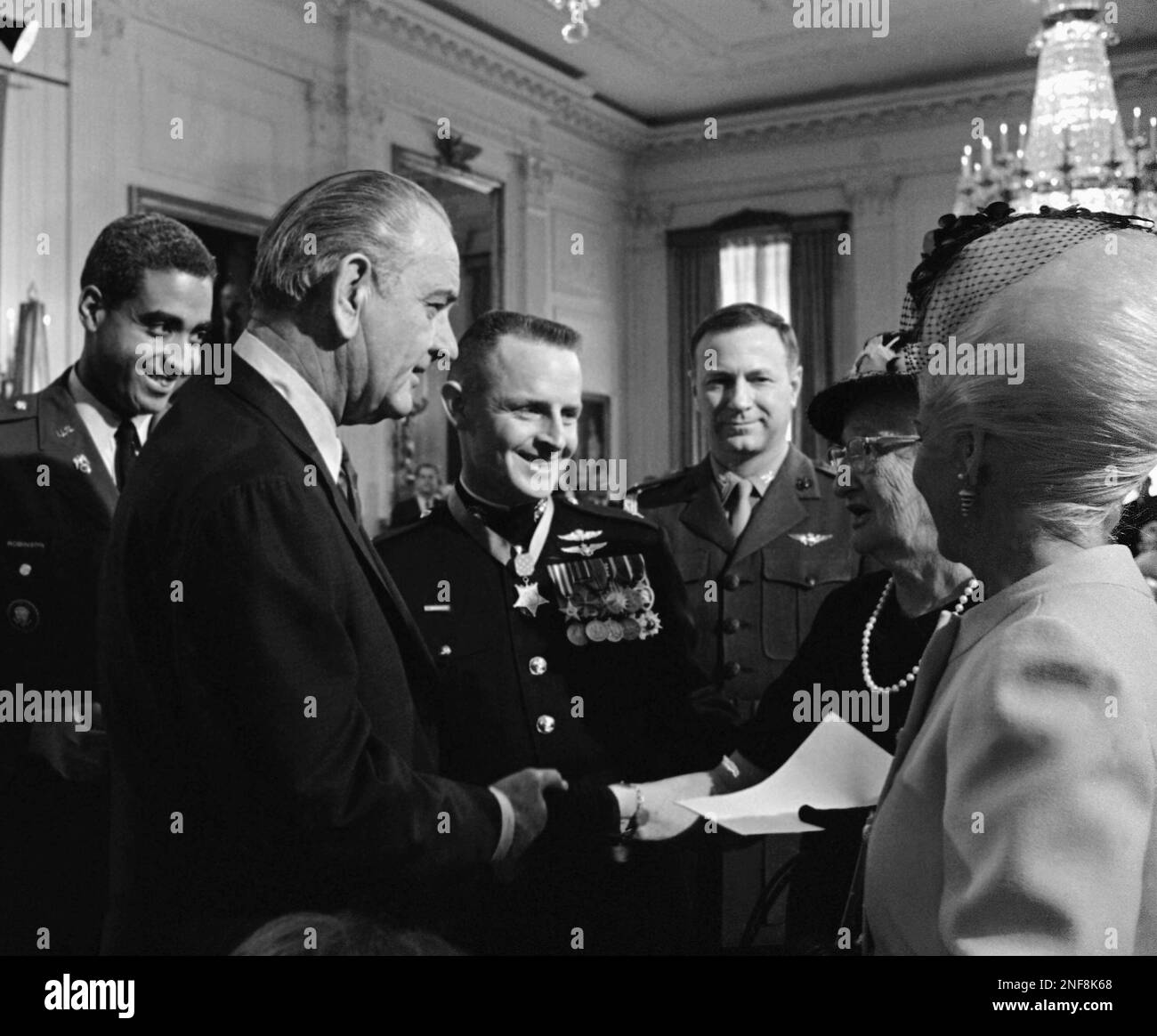 Marine Major Stephen W. Pless, wearing his Medal of Honor, introduces ...