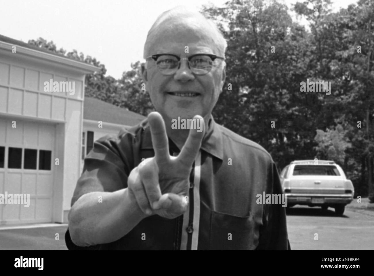 Colonel Edwin Aldrin Sr. smiles and makes a "V" sign outside his home ...
