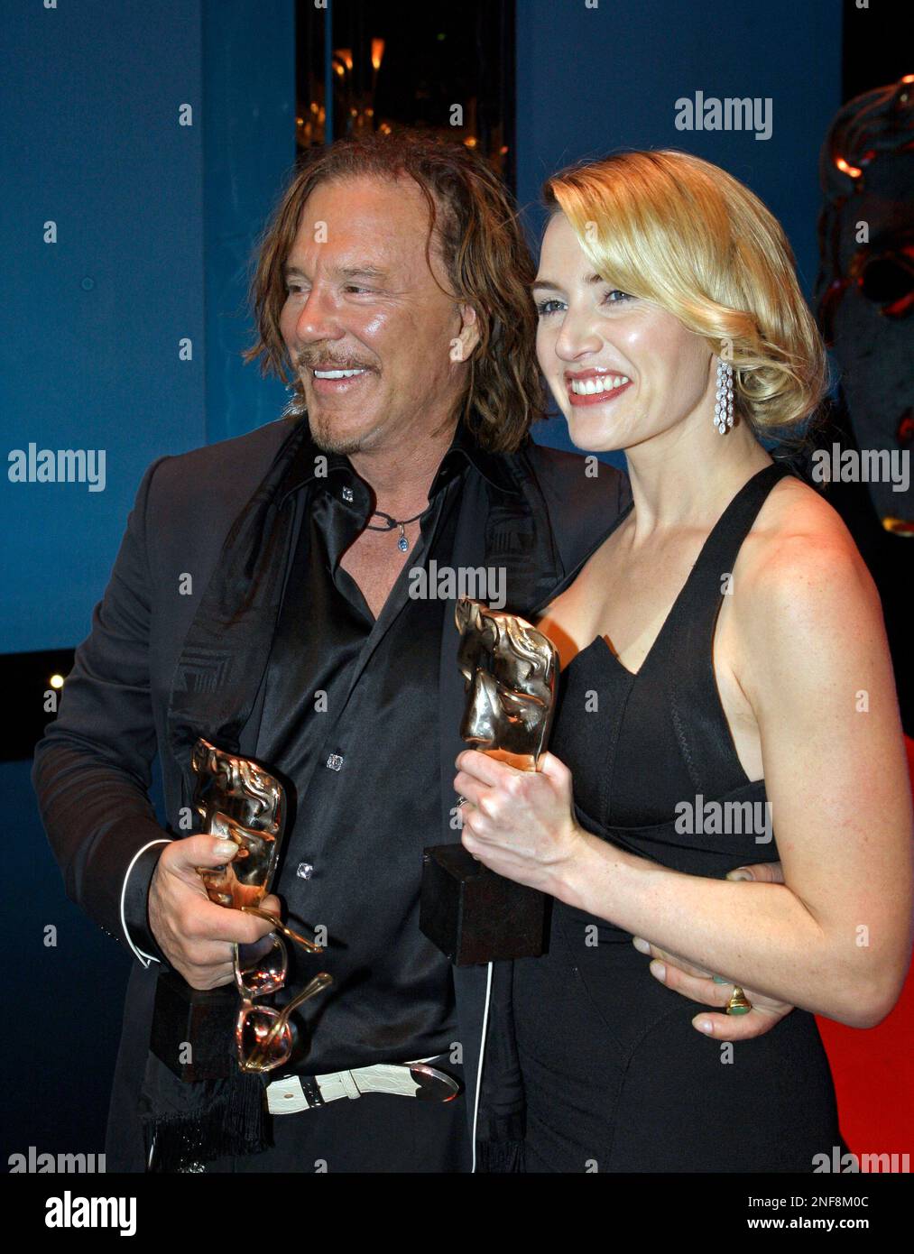 US actor Mickey Rourke, left, with his Best Actor award for his role in ...
