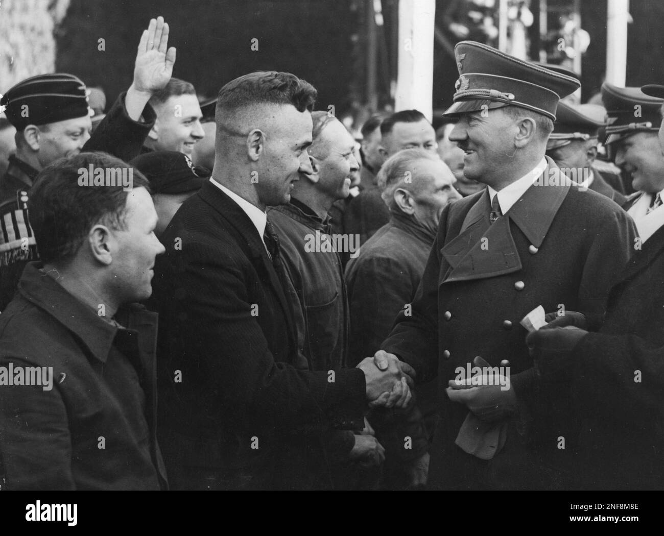 Adolf Hitler, is pictured shaking hands with a dock worker of the ...