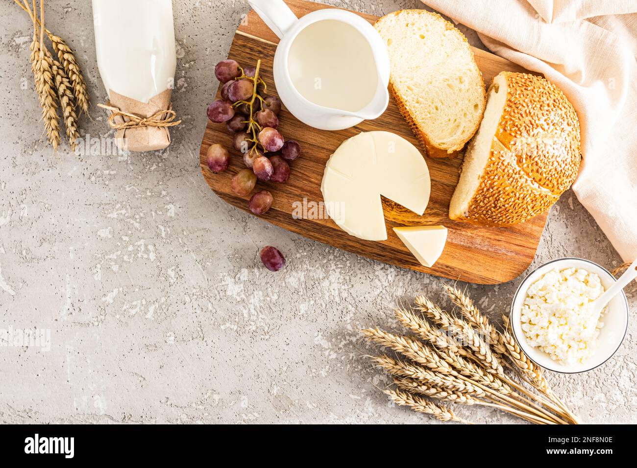 fresh dairy products, a loaf of bread, a bouquet of ears of corn ...