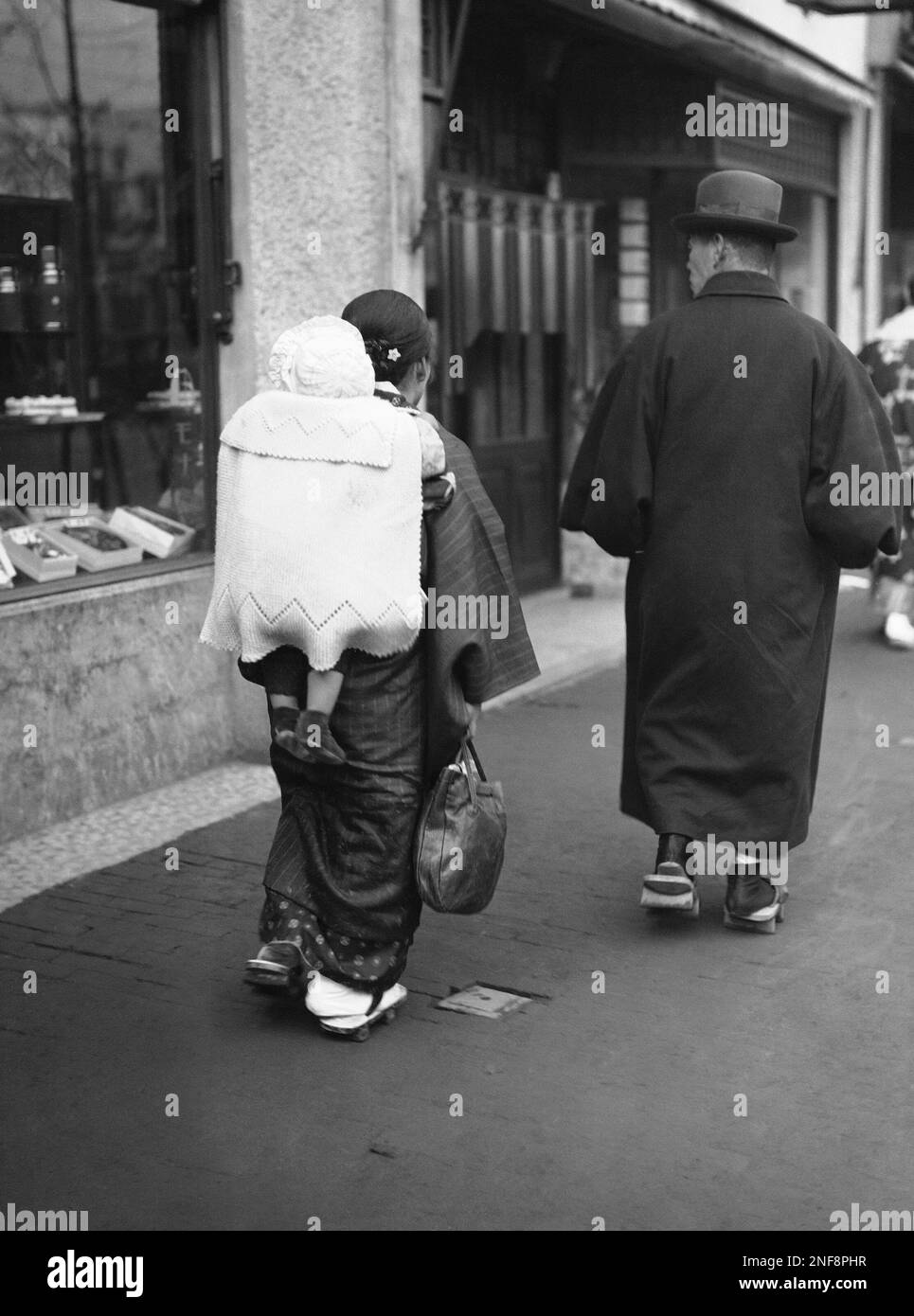 A Japanese family in traditional dress takes a stroll in Tokyo's Ginza ...