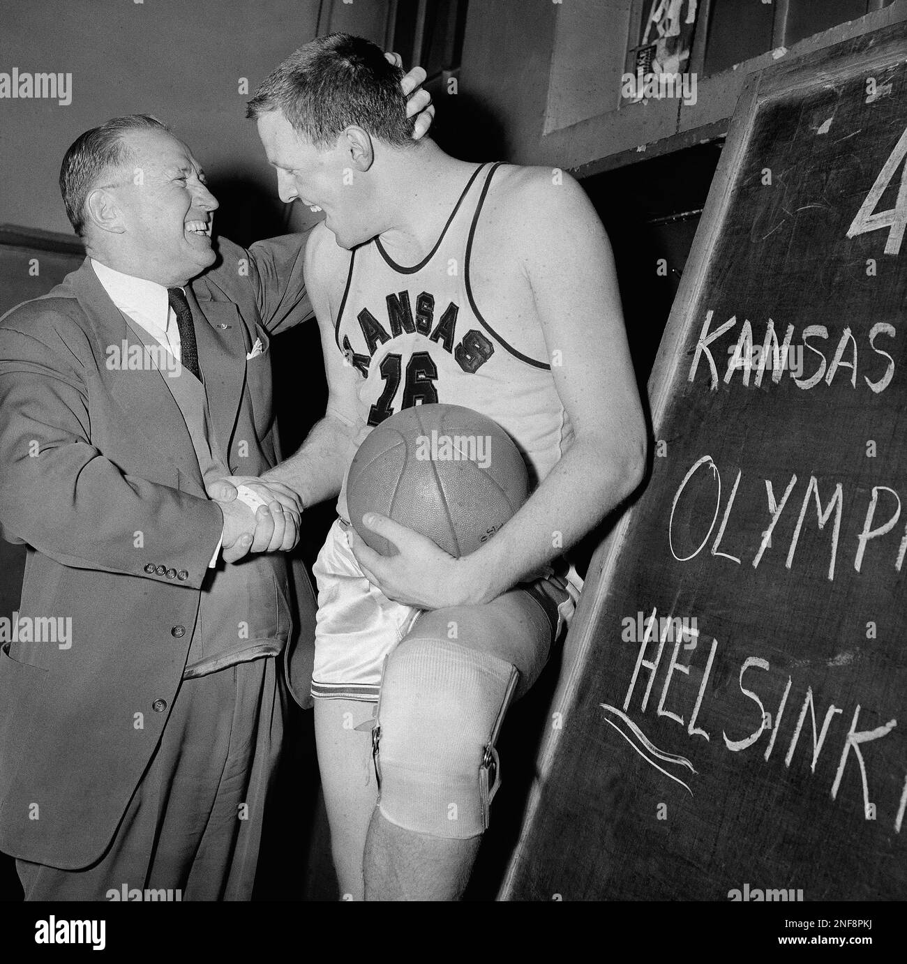 Kansas Coach Forrest Allen, left, congratulates his giant center Clyde ...